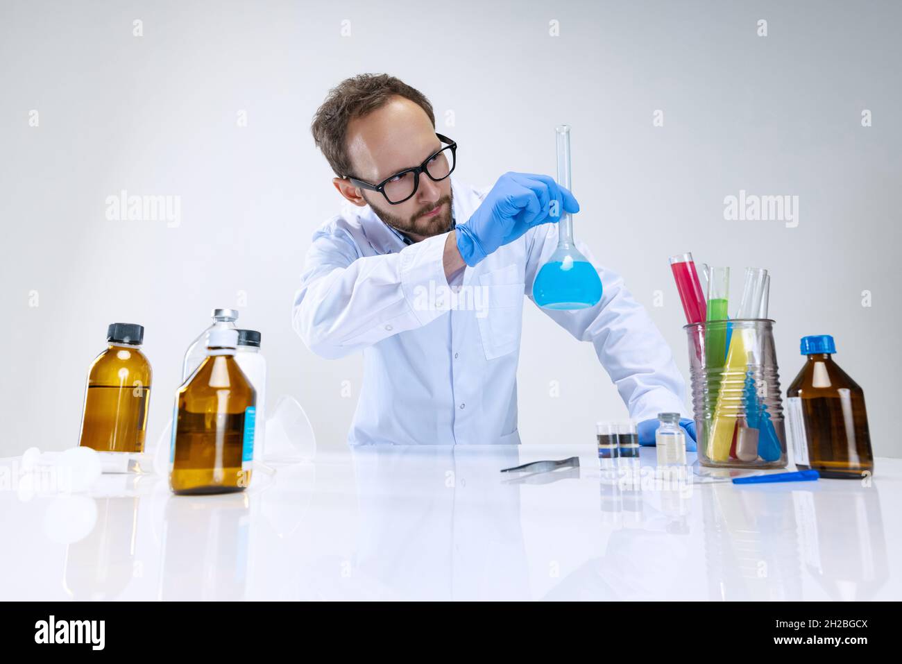Portrait of young scientist, chemist or doctor conducts chemical ...