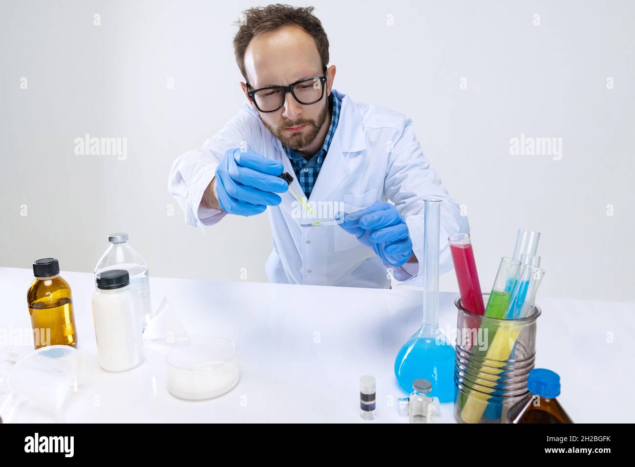 Portrait of young scientist, chemist or doctor conducts chemical ...