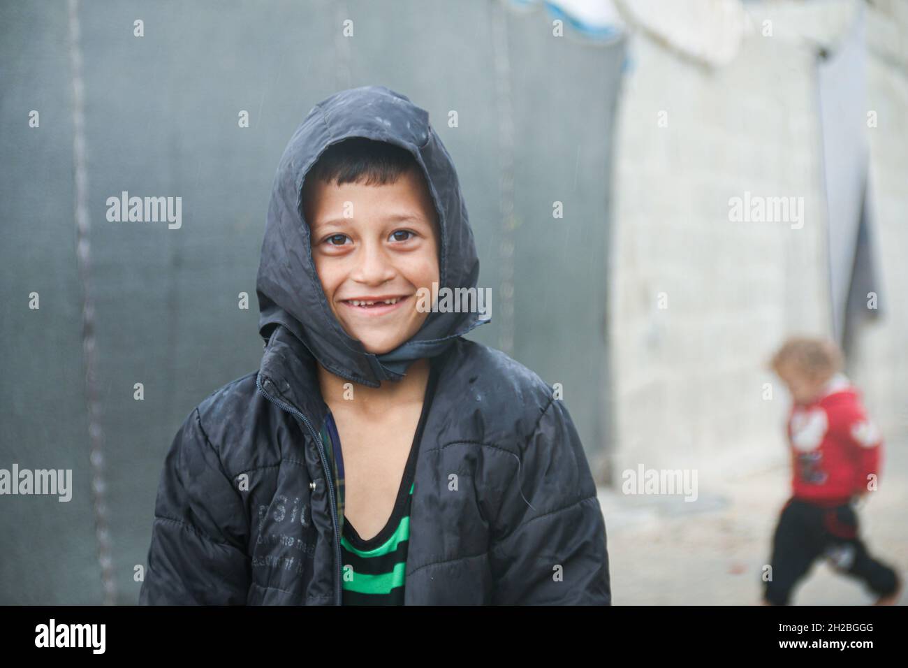 A portrait of a sweet refugee child in the camp. Syrian refugees Stock ...