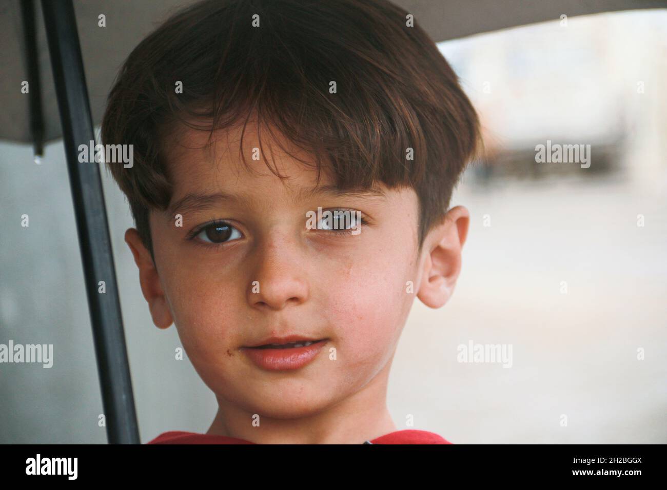 A portrait of a sweet refugee child in the camp. Syrian refugees Stock ...