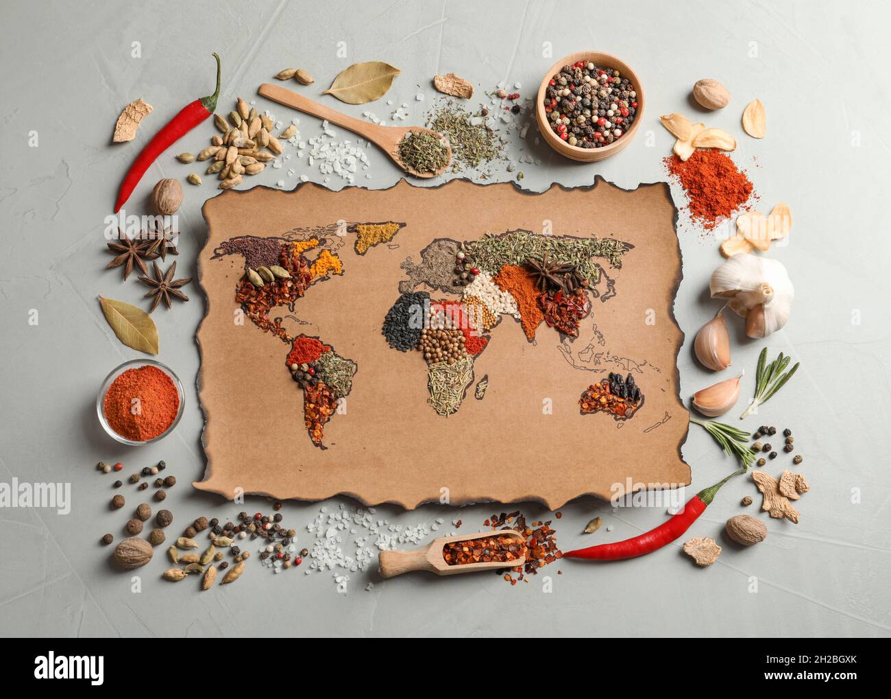 Paper with world map made of different aromatic spices on gray ...