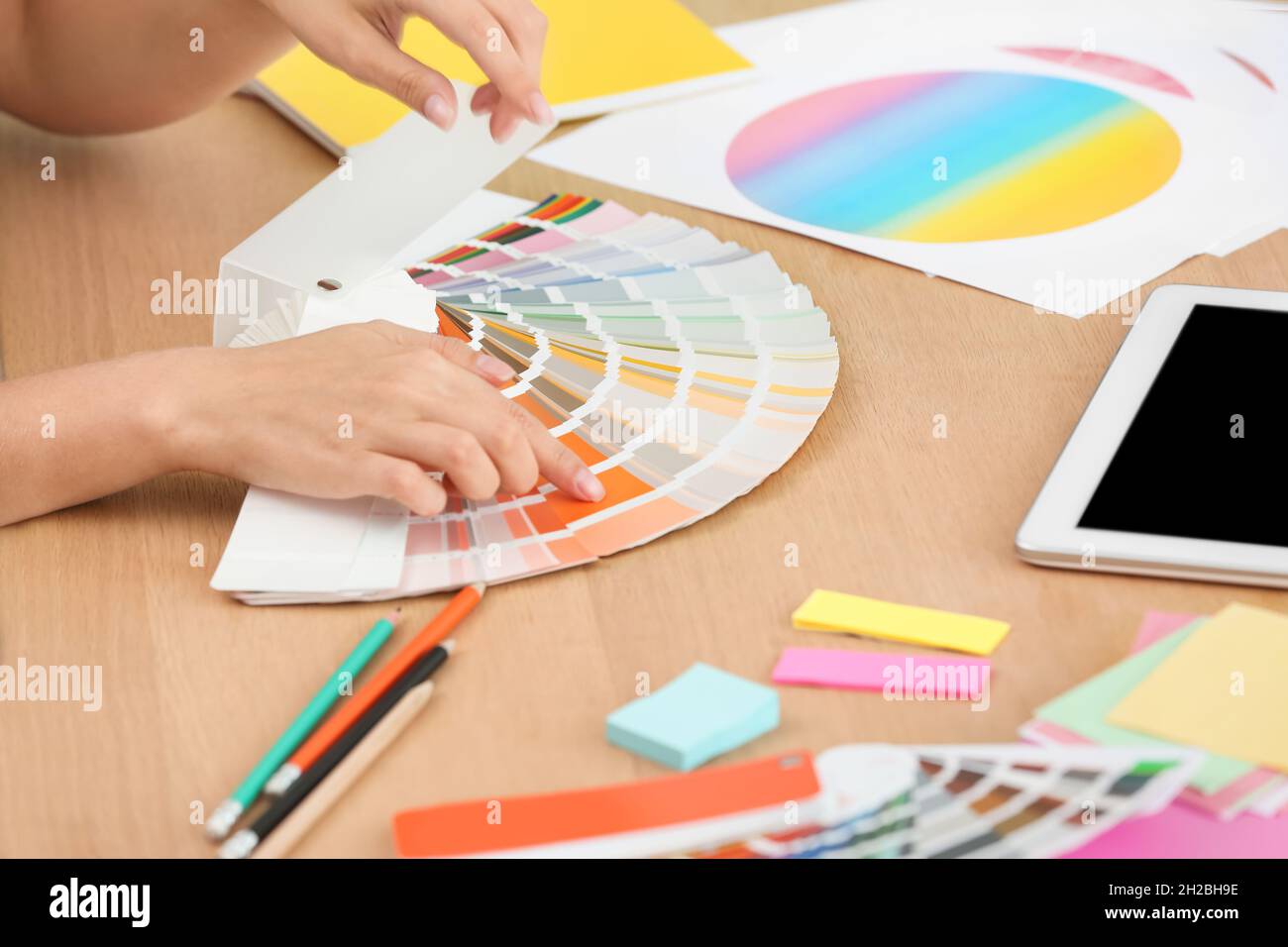 Designer with paint color palette samples at table, closeup Stock Photo ...
