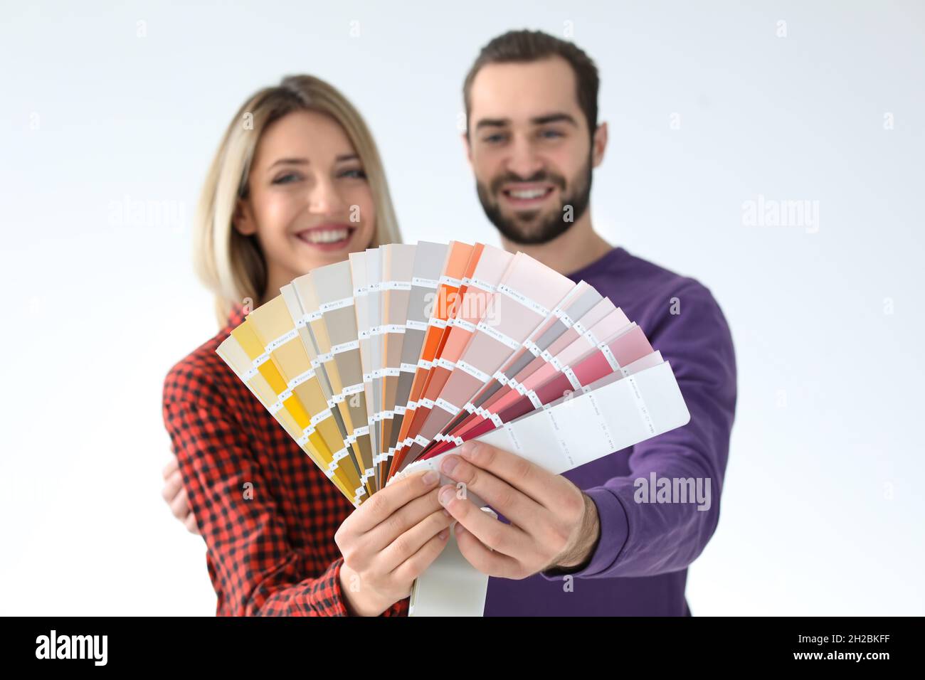Young couple with color palette on white background Stock Photo - Alamy