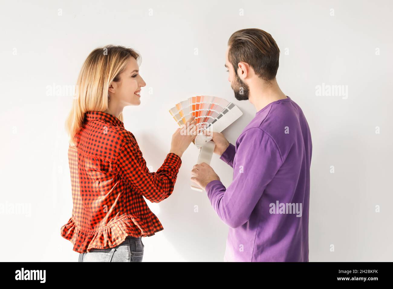 Young couple with color palette on white background Stock Photo - Alamy