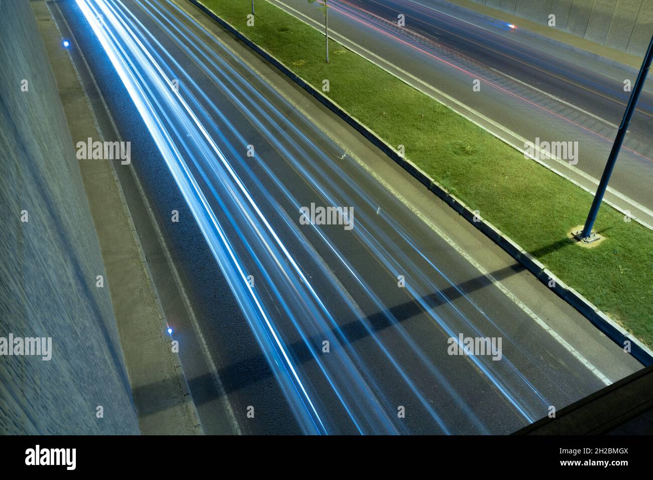 Light trails on the underpass road at night. Traffic or highway ...