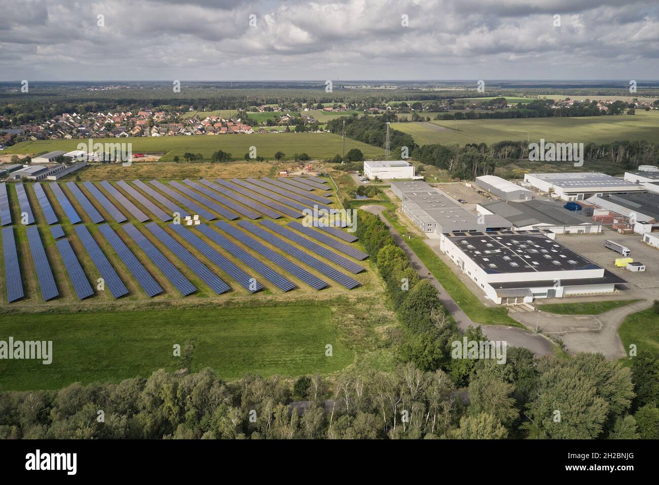 Aerial view of a large solar plant with solar panels on the edge of a ...