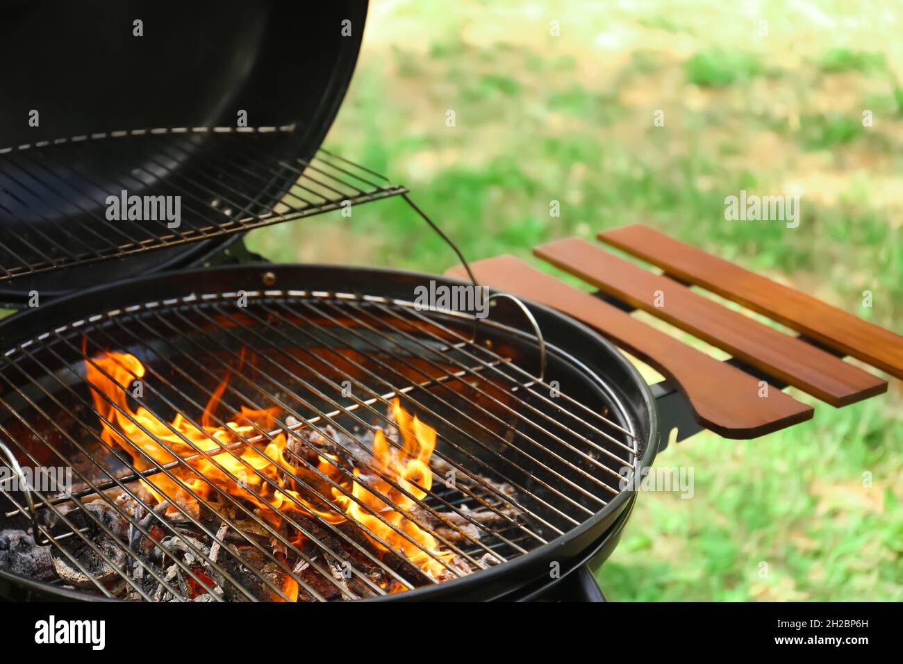 Modern barbecue grill with fire flames outdoors, closeup Stock Photo ...