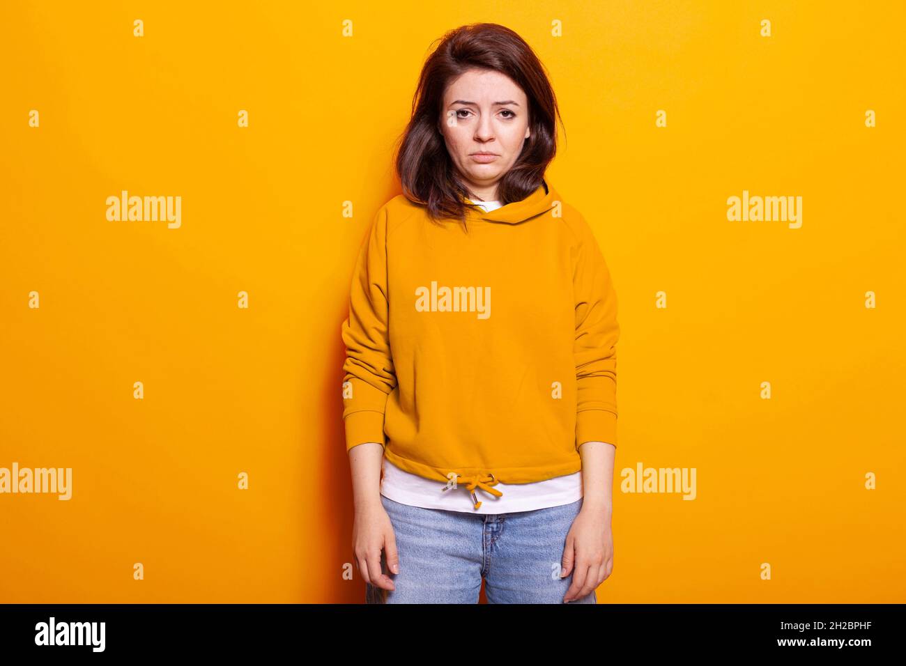 Portrait of young adult feeling sad and disappointed on camera ...