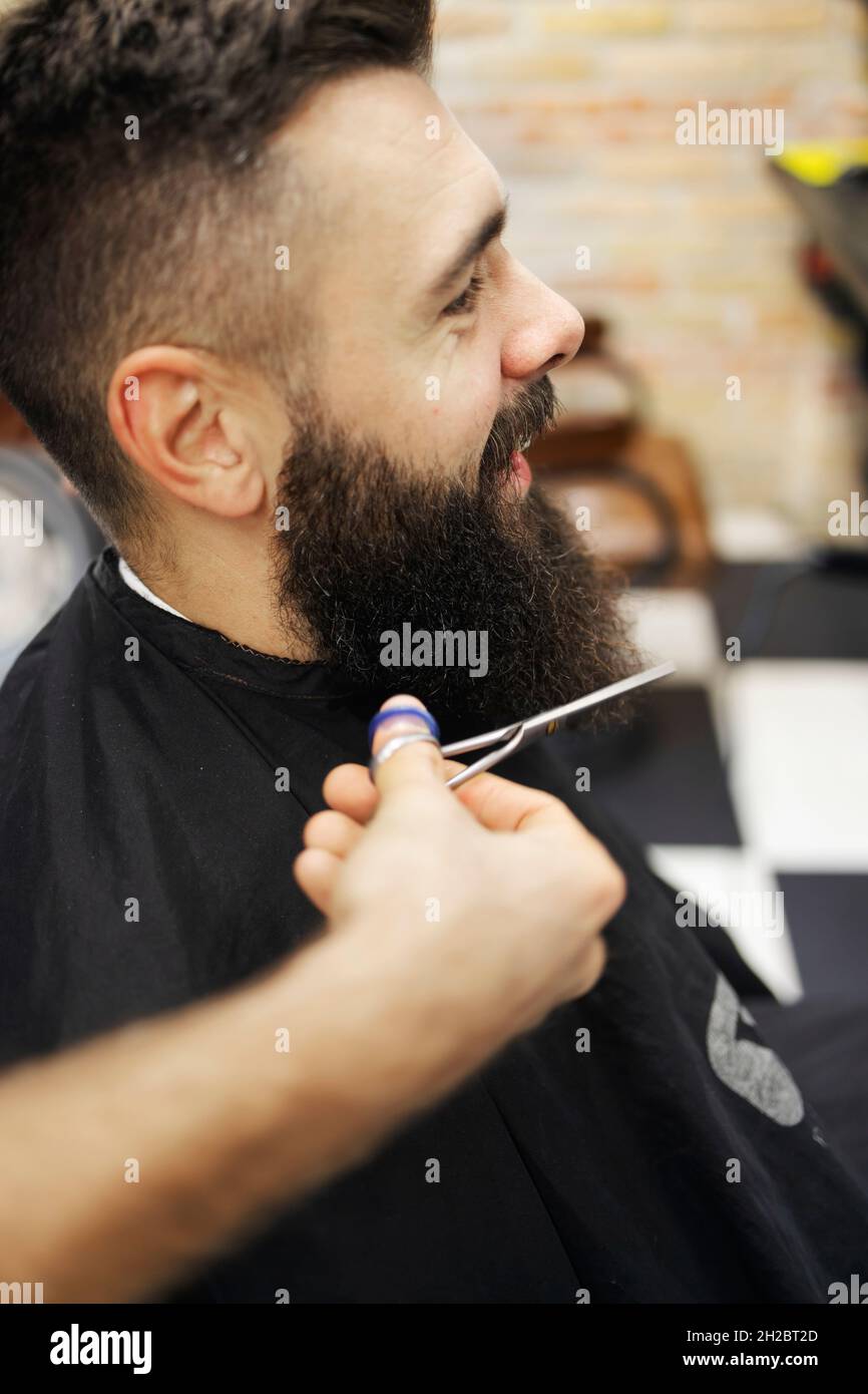 Detail of a beard trimming in a hair salon Stock Photo - Alamy