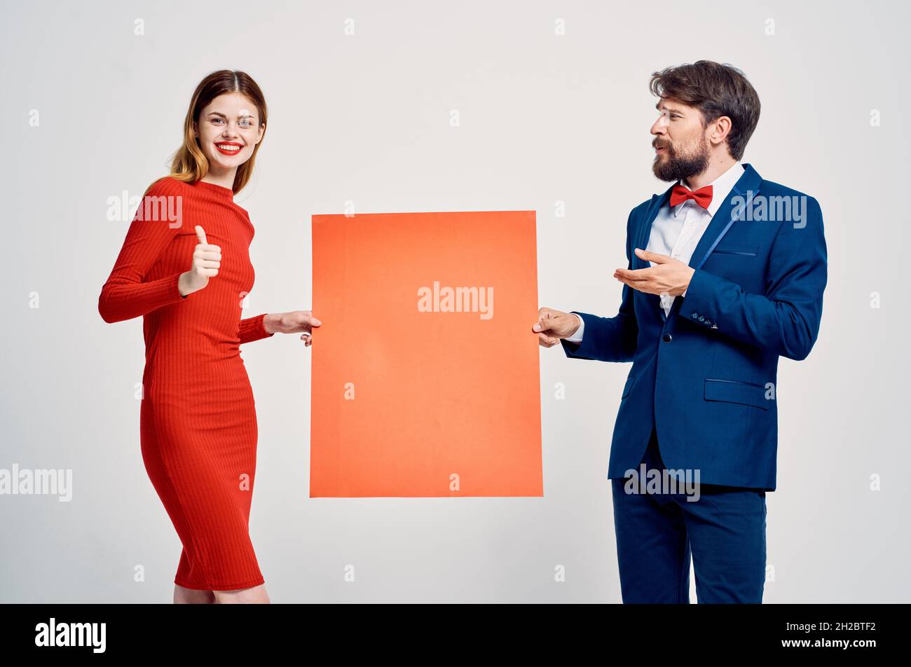 national man and woman holding on to mocap poster advertising Stock ...
