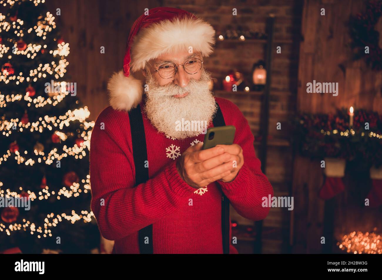 Photo of aged santa claus happy positive smile chat type sms cellphone ...