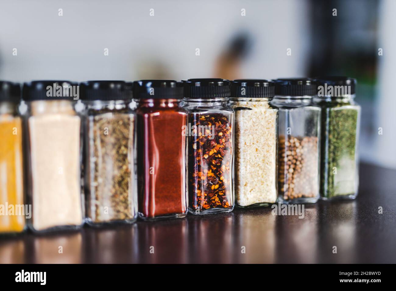 spices seeds and seasonings in matching spice jars on tidy pantry shelf ...