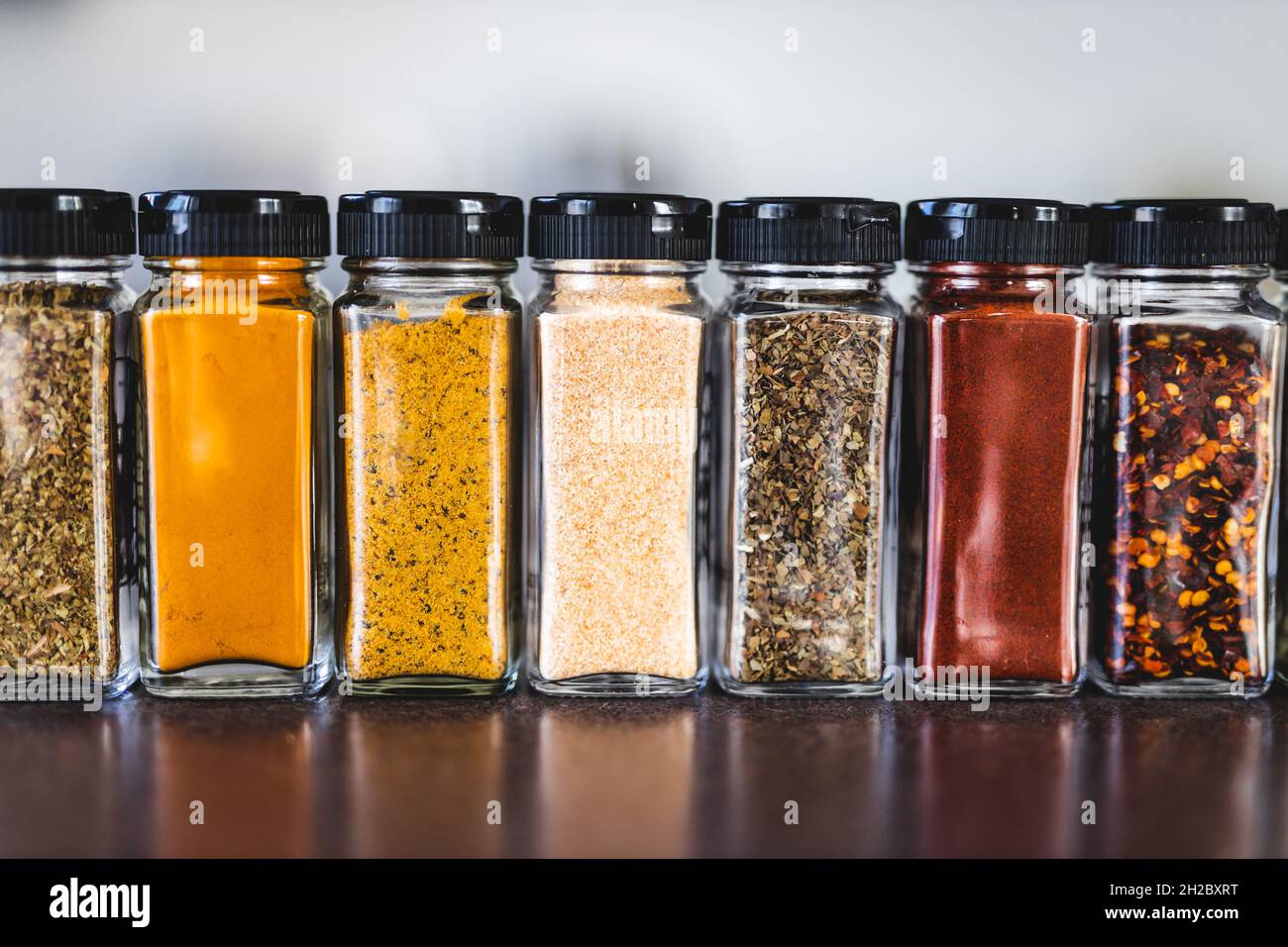 spices seeds and seasonings in matching spice jars on tidy pantry shelf ...