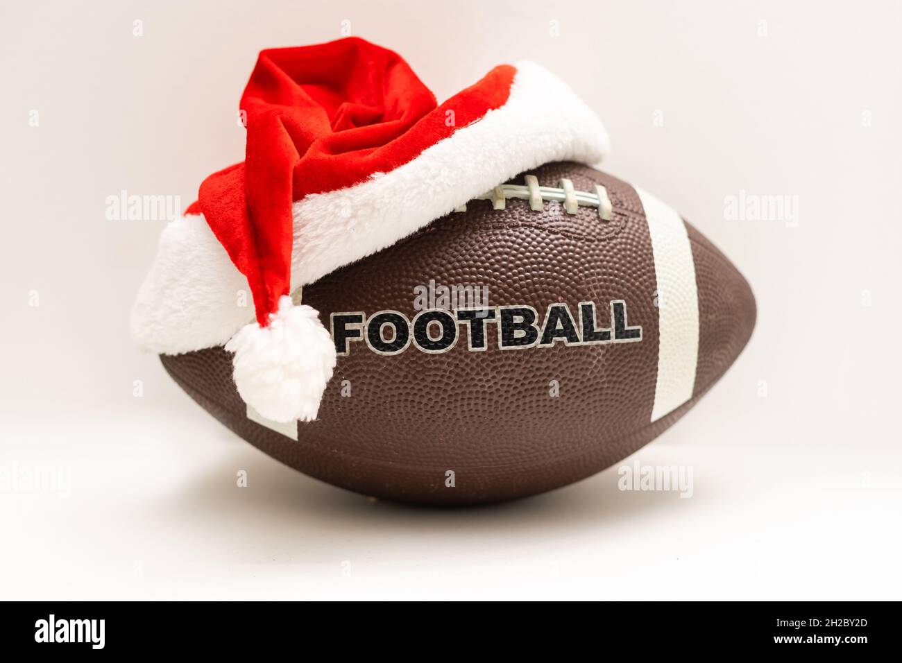 Rugby ball and red cap isolated on white background Stock Photo - Alamy