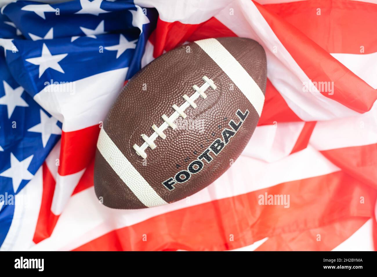 American football rugby ball against american flag Stock Photo - Alamy