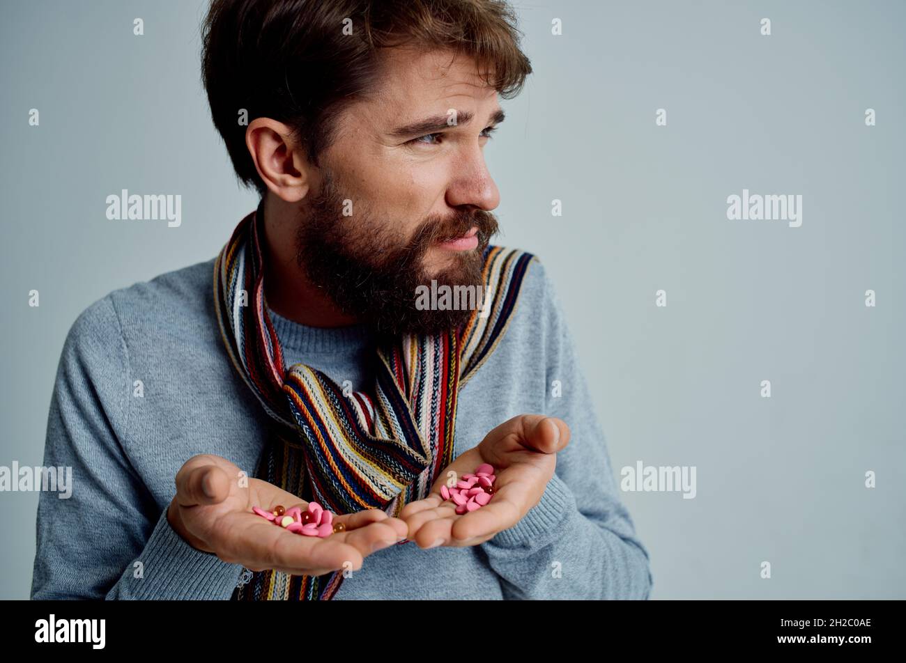 sick man with a scarf around his neck flu health problems light ...