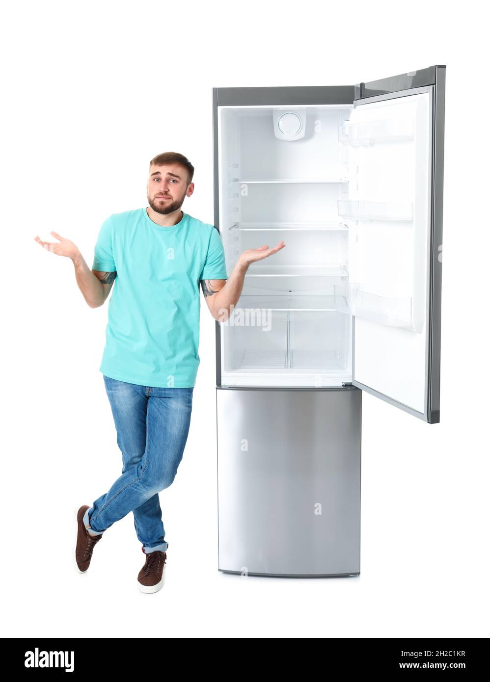 Emotional man near empty refrigerator on white background Stock Photo ...