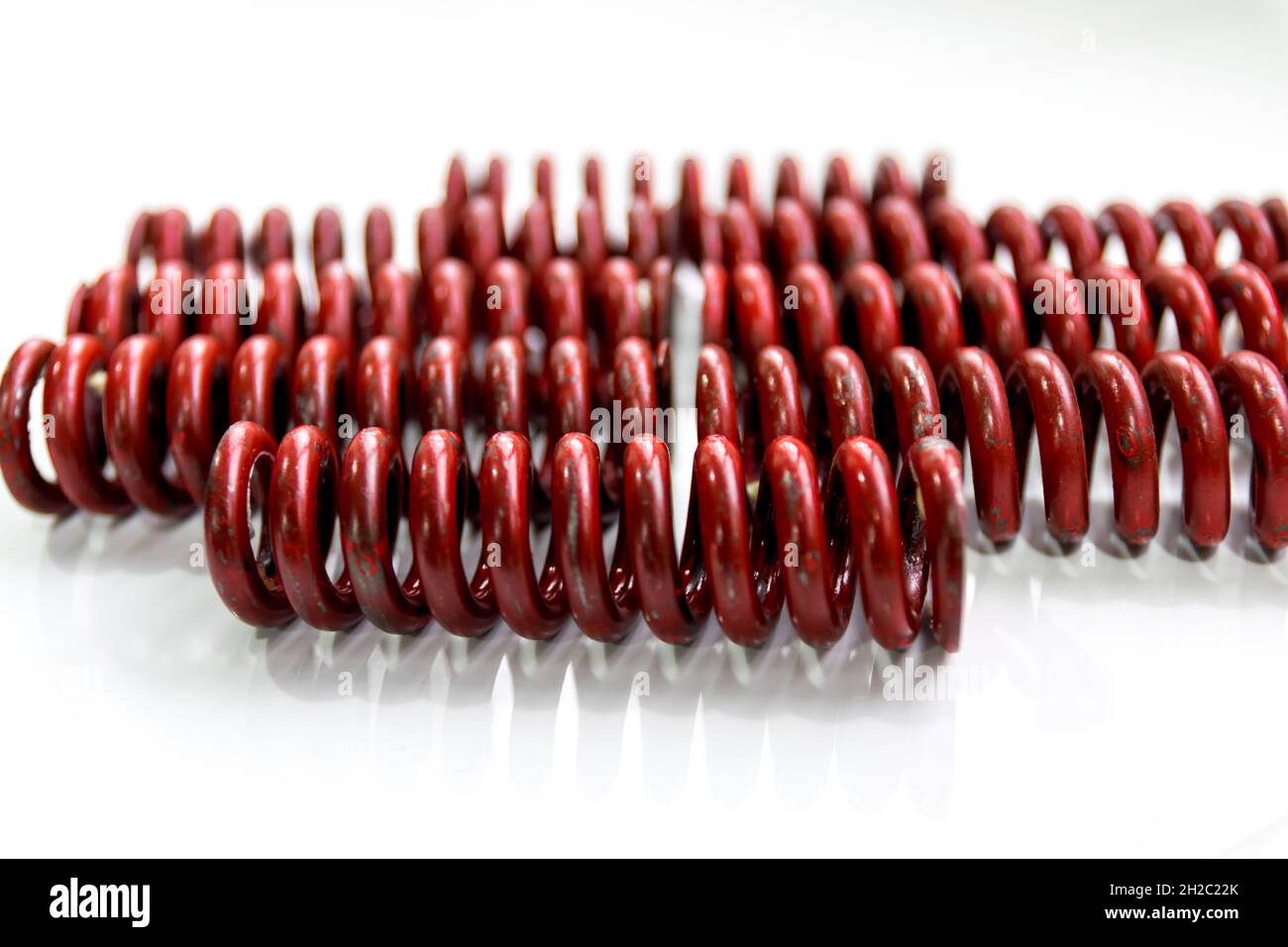 Group of iron red springs isolated on white background Stock Photo - Alamy