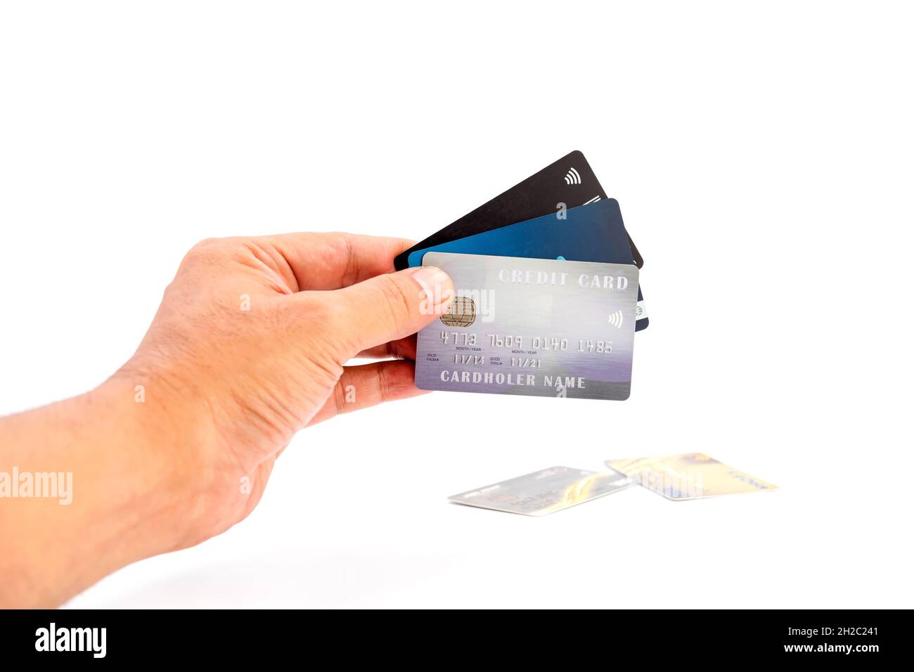 Human hand holding group of bank credit cards on white background, use ...