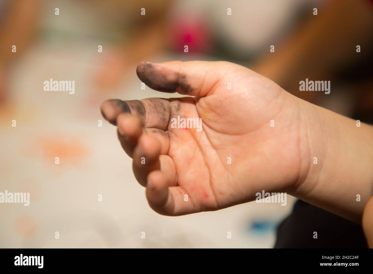 The child's right hand hangs to the side. The soot-stained, gunpowder ...