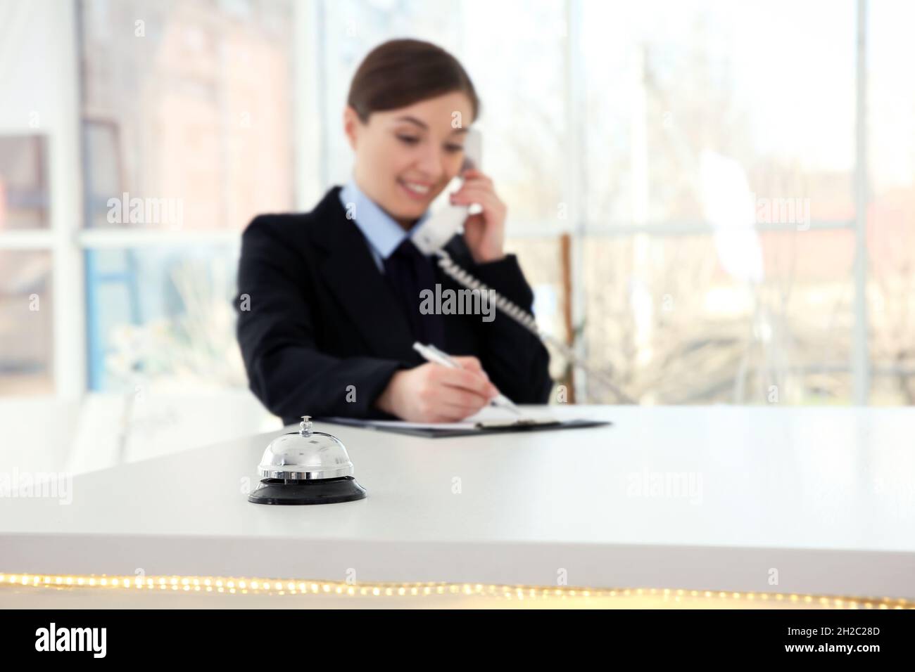 Service bell and female receptionist in hotel Stock Photo - Alamy