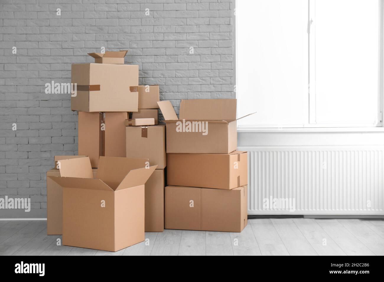 Cardboard boxes on floor indoors Stock Photo - Alamy