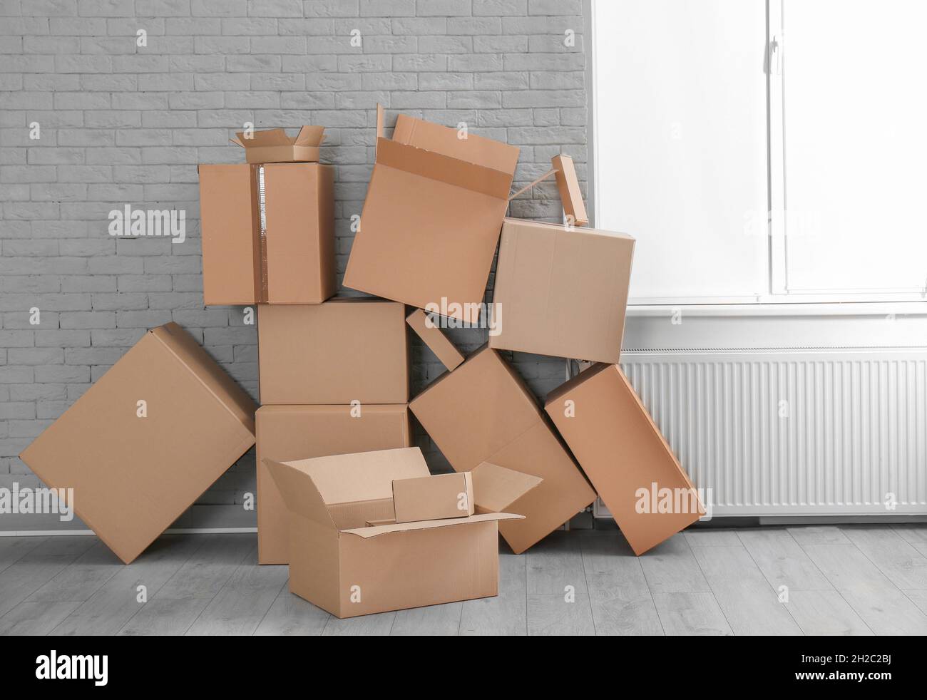 Cardboard boxes on floor indoors Stock Photo - Alamy