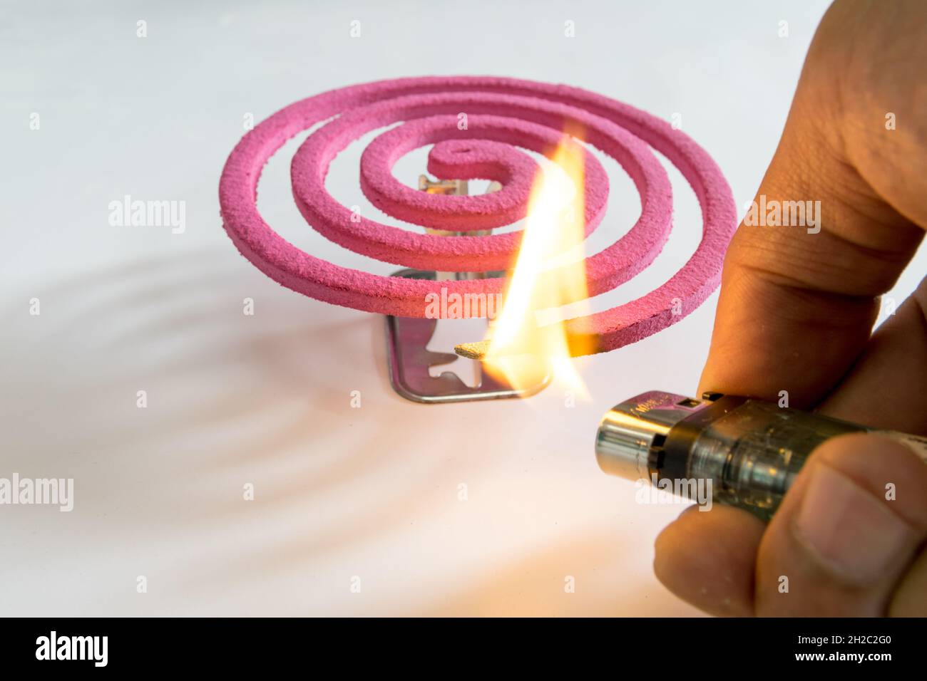 Pink mosquito repellent on white background Stock Photo - Alamy