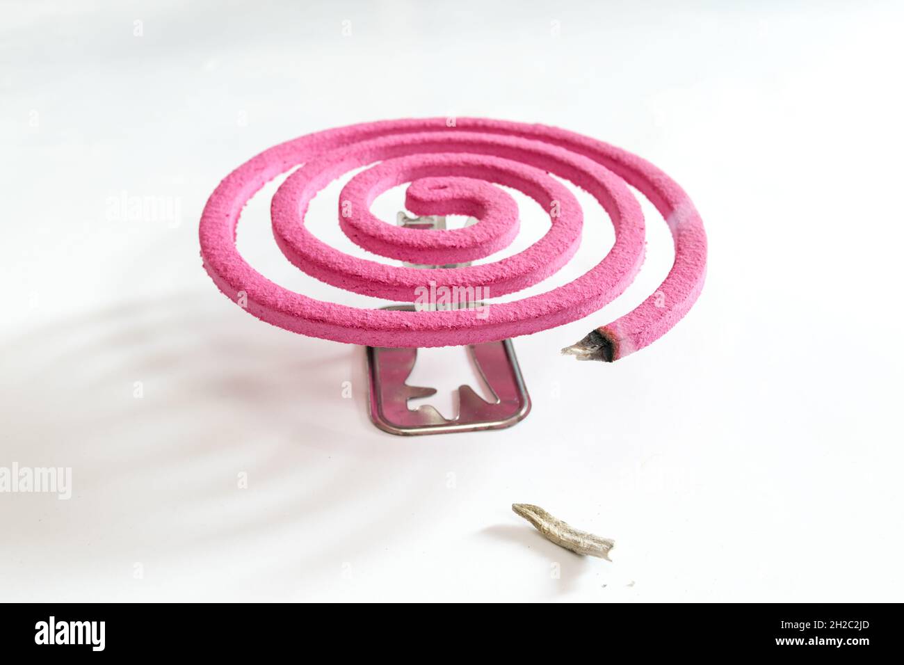 Pink mosquito repellent on white background Stock Photo - Alamy