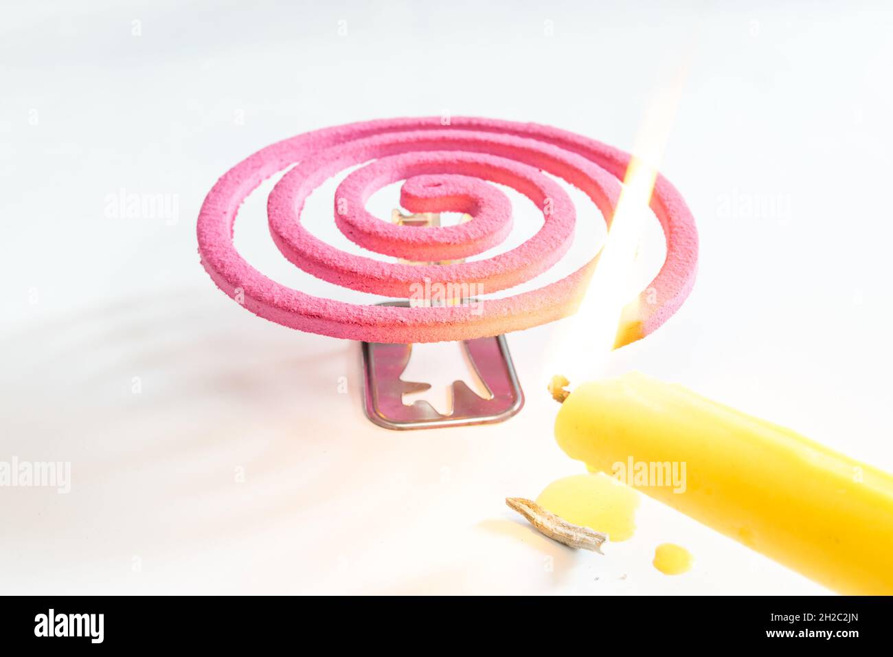 Pink mosquito repellent on white background Stock Photo - Alamy