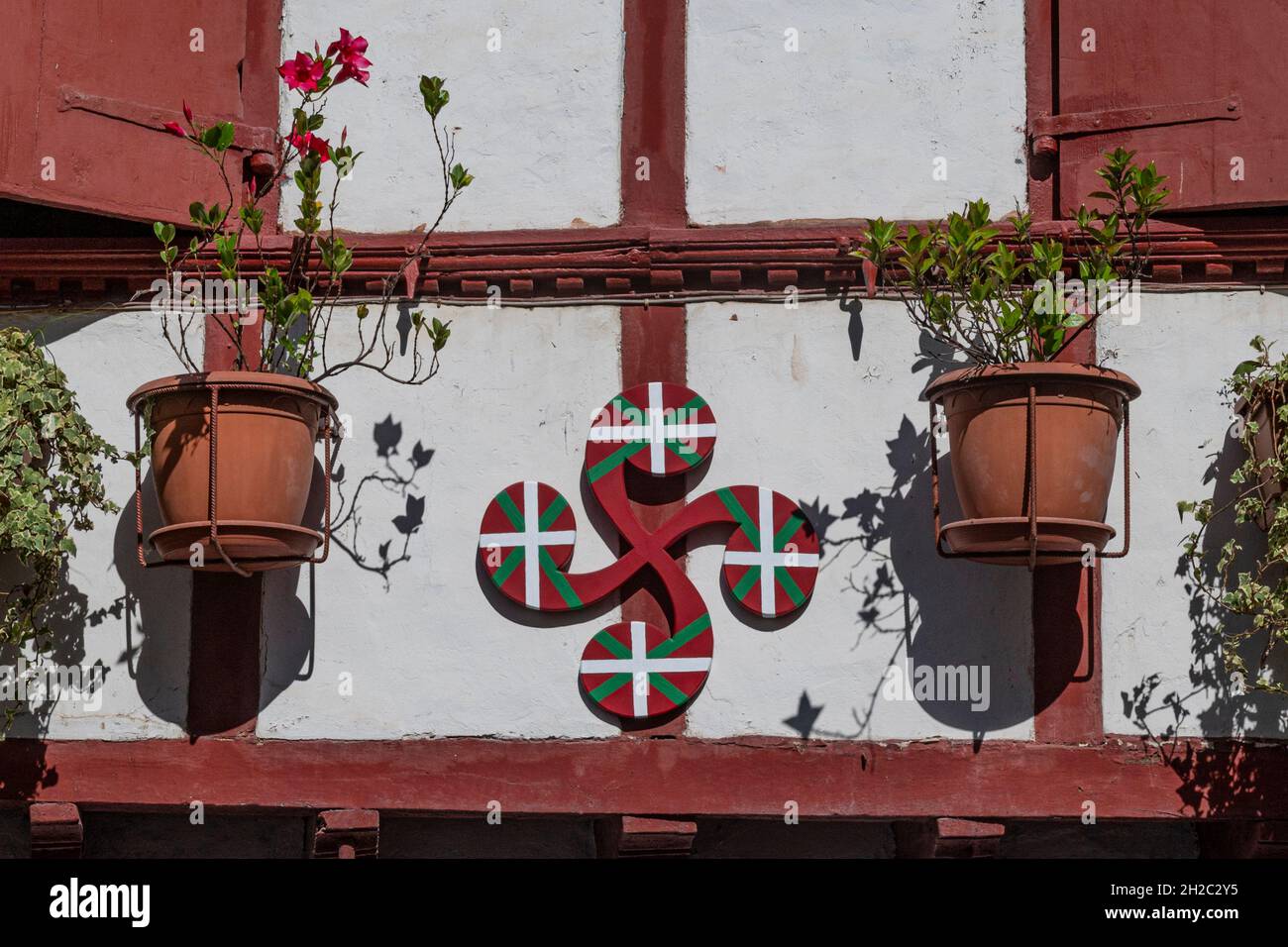 Traditional basque house featuring the "lauburu" symbol in the old town ...