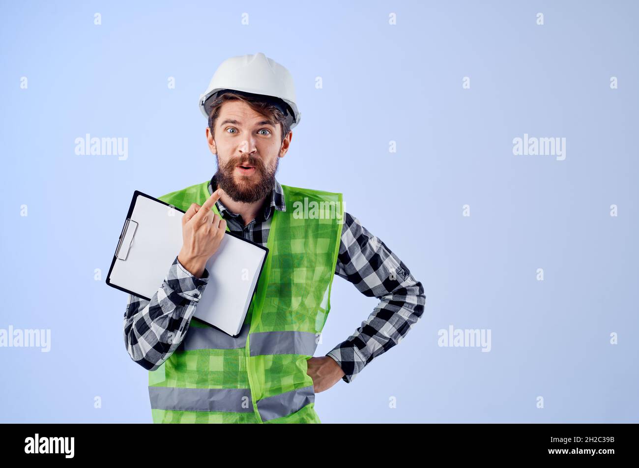 engineer in a white helmet blueprints Professional blue background ...
