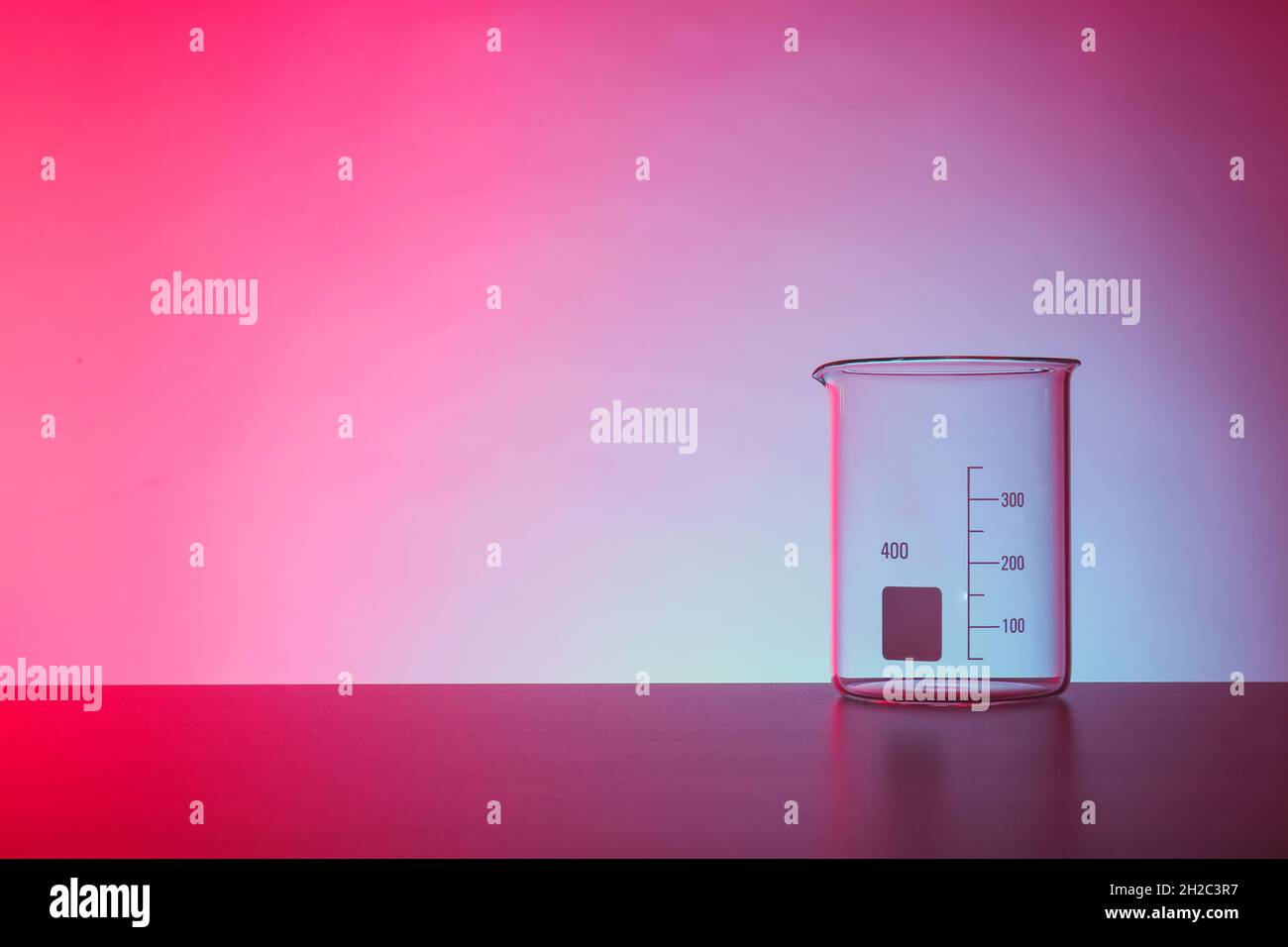 Empty beaker on table against color background. Chemistry laboratory ...