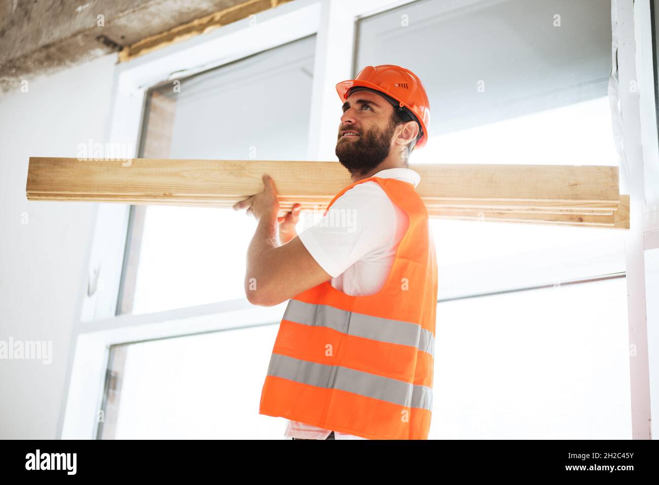 Builder carrying wood on shoulder hi-res stock photography and images ...