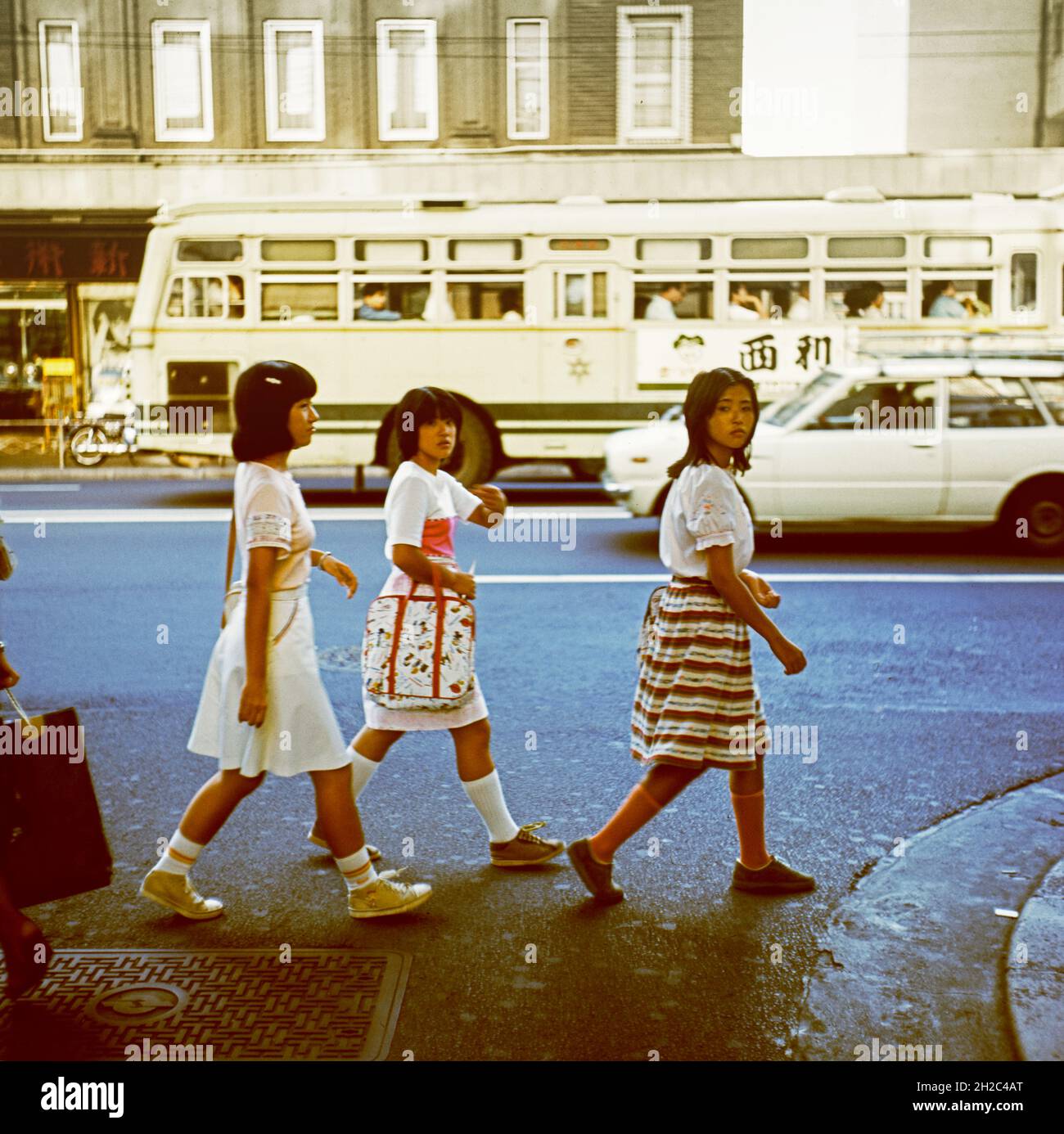 Teenage girls walk down the street. Japan, 1970s Stock Photo - Alamy