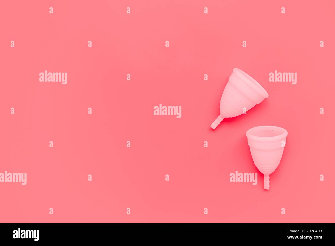 Pink menstrual cup on color background, female intimate hygiene period ...