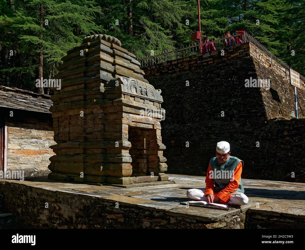 Priest reading sacred book in front of temple Stock Photo - Alamy