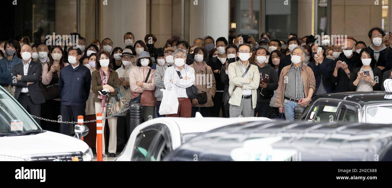 People listen to a politician giving a stump speech in Nagoya, central ...