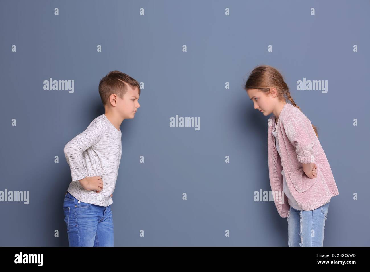 Brother arguing with sister on color background Stock Photo - Alamy