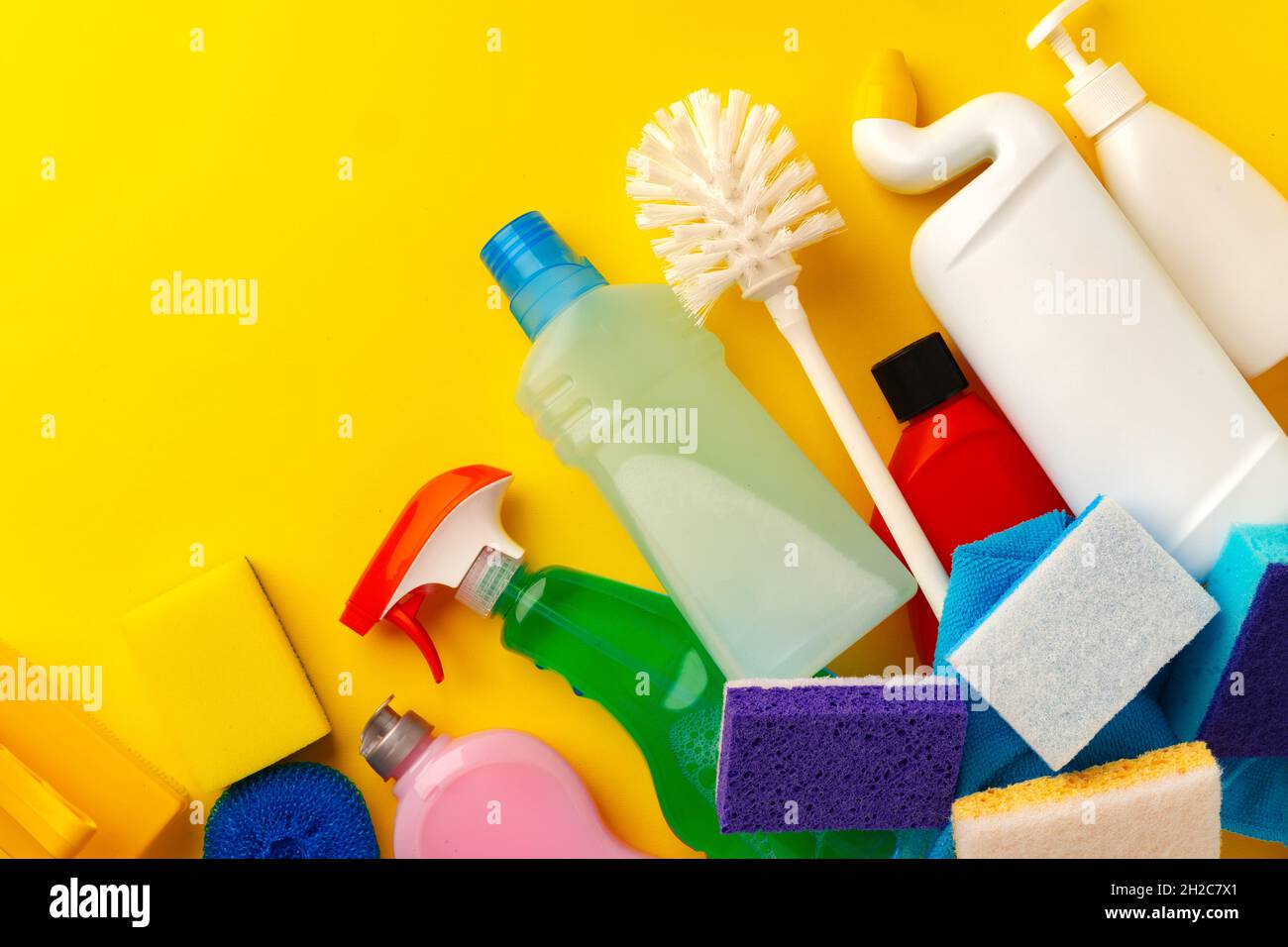 Set of cleaning supplies on yellow color background Stock Photo - Alamy