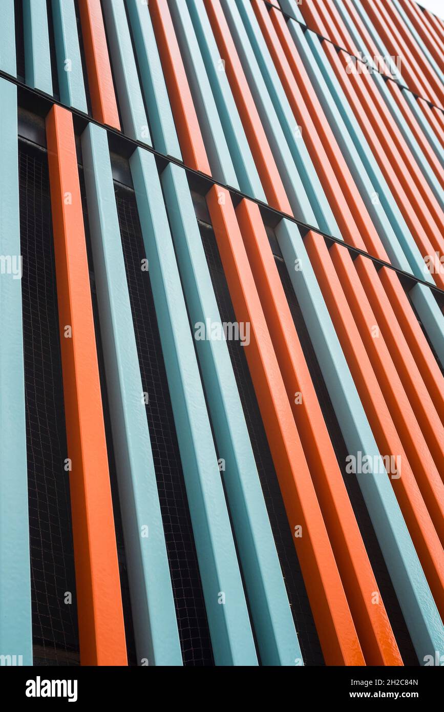Modern plant building clad in powder-coated steel tube to brighten an ...
