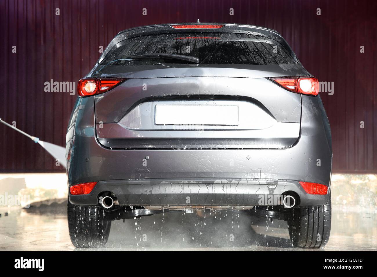 Cleaning automobile with high pressure water jet at car wash Stock ...