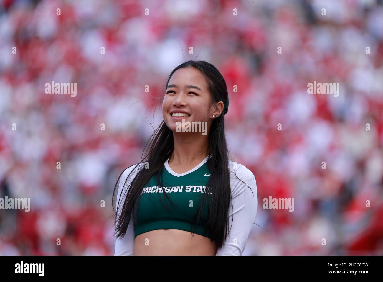 A Michigan State cheerleader cheers for the Spartans during an NCAA ...