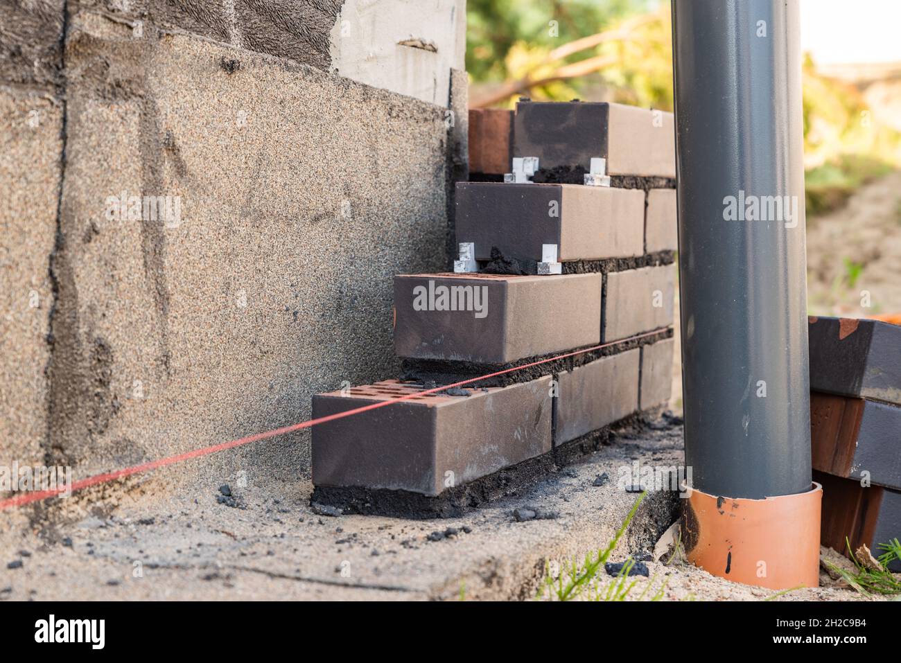 brick plinth around the house Stock Photo - Alamy