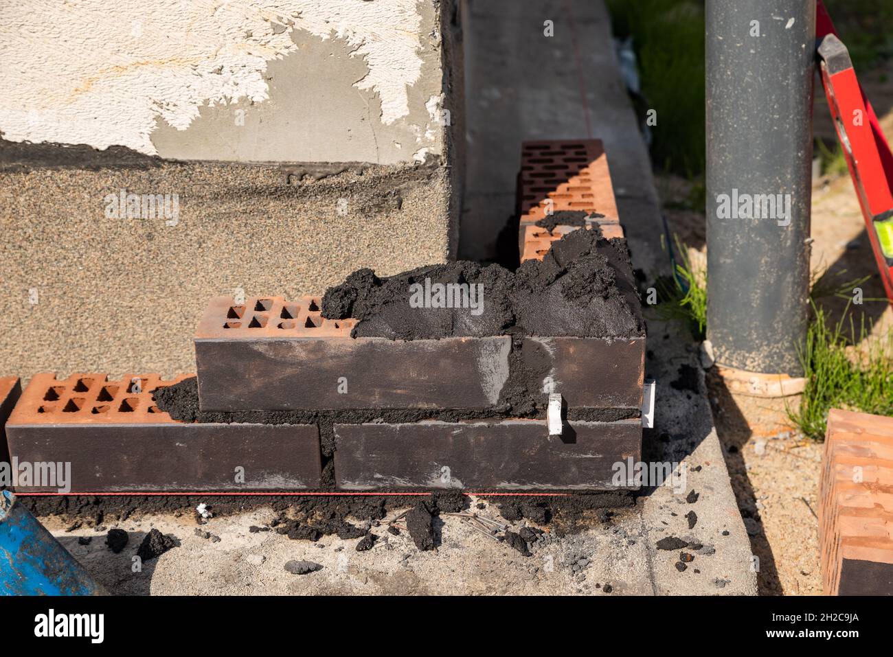 brick plinth around the house Stock Photo - Alamy