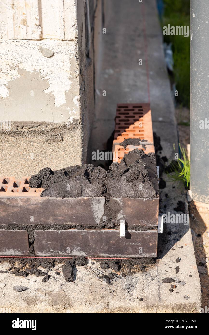brick plinth around the house Stock Photo - Alamy