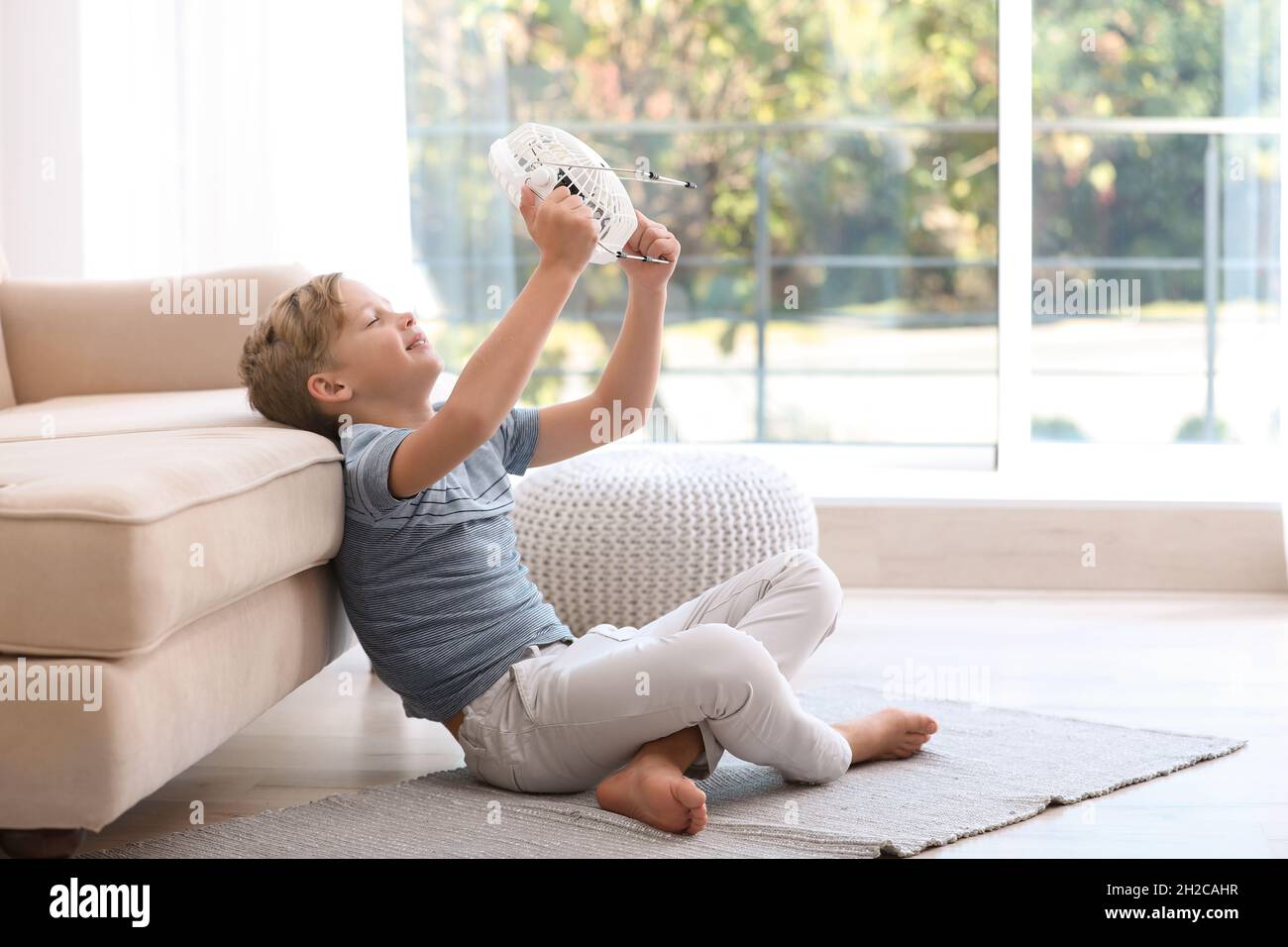 Fan blowing boy hi-res stock photography and images - Alamy