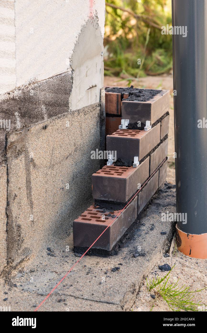 brick plinth around the house Stock Photo - Alamy