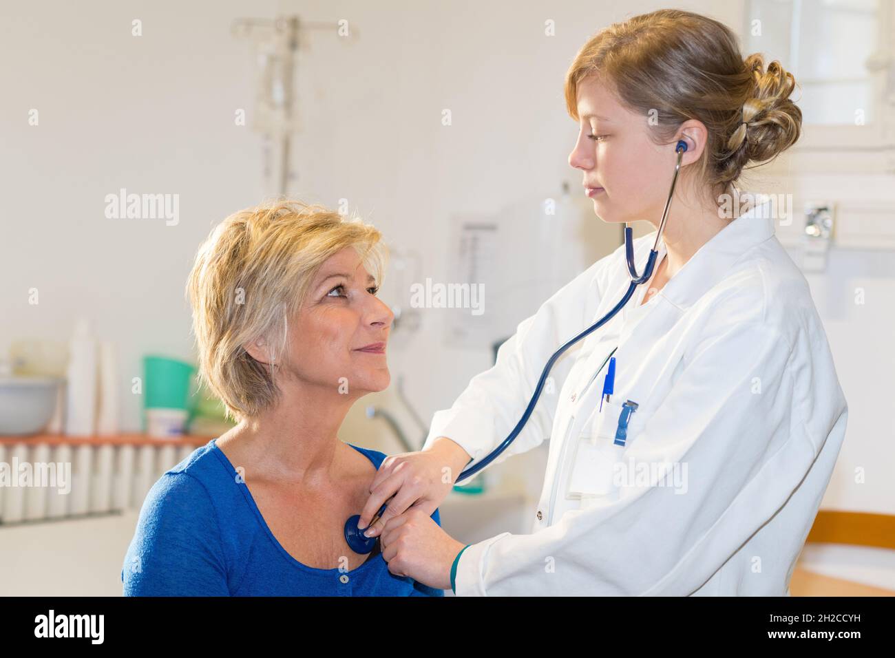 female doctor checking on female patient heart rate Stock Photo - Alamy