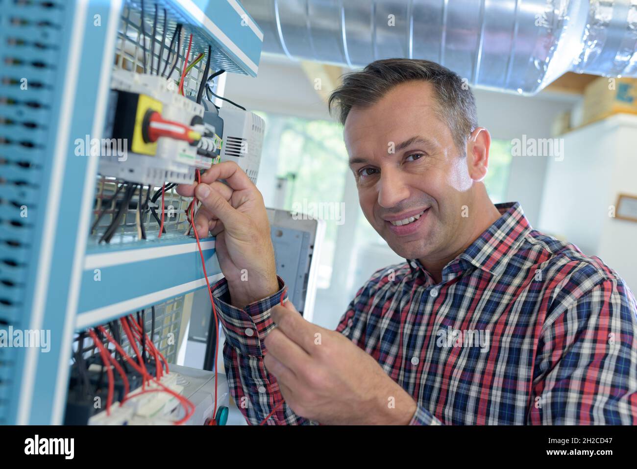 happy man holds server cable in server rack Stock Photo - Alamy